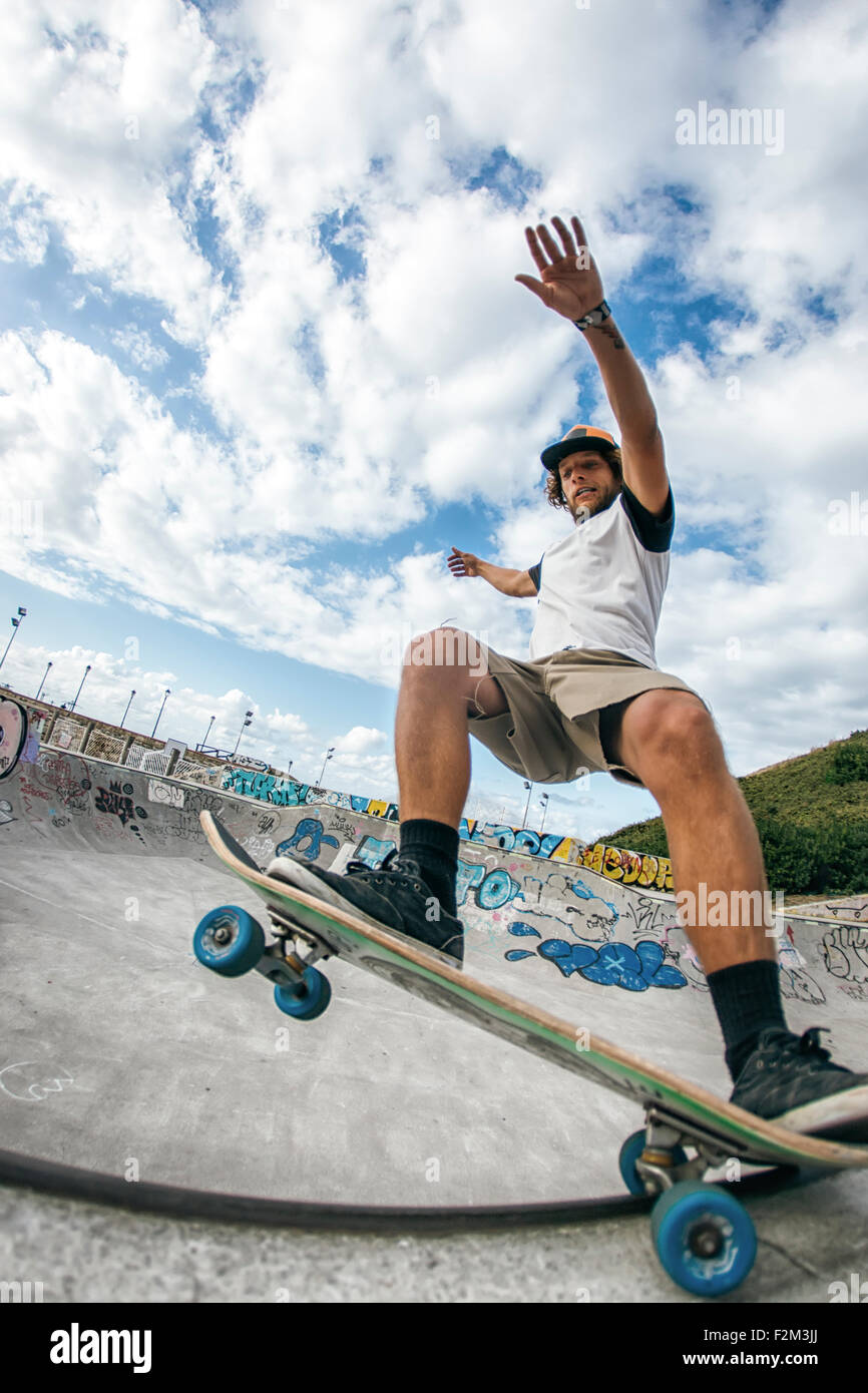 Young man skateboarding in a skatepark Stock Photo - Alamy