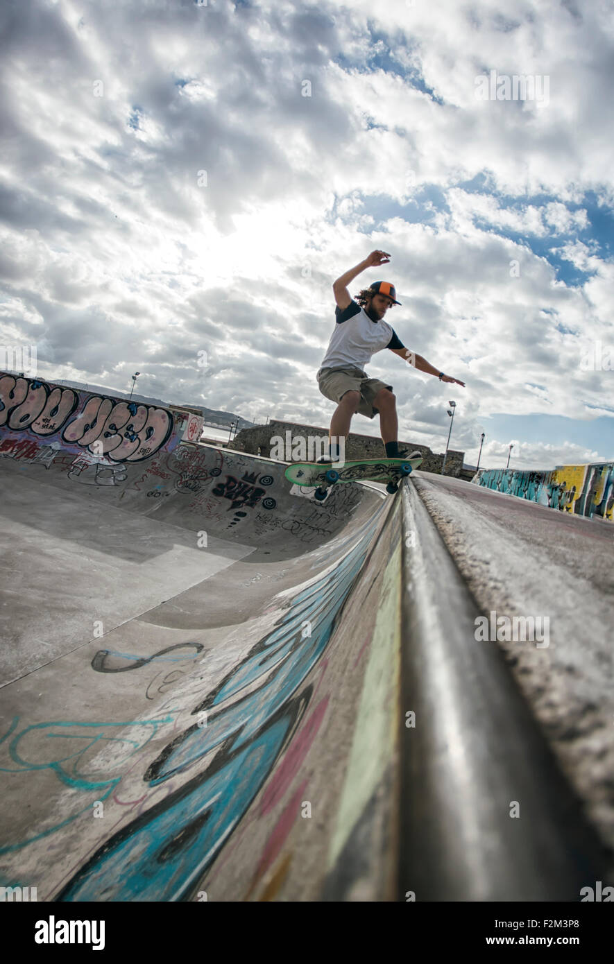 Young man skateboarding in a skatepark Stock Photo - Alamy