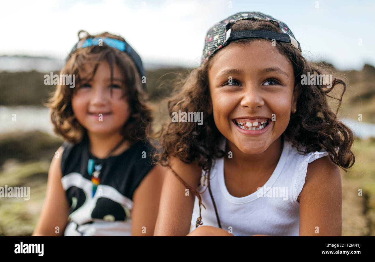 Spain, Gijon, portrait of smiling little girl and her friend in the ...