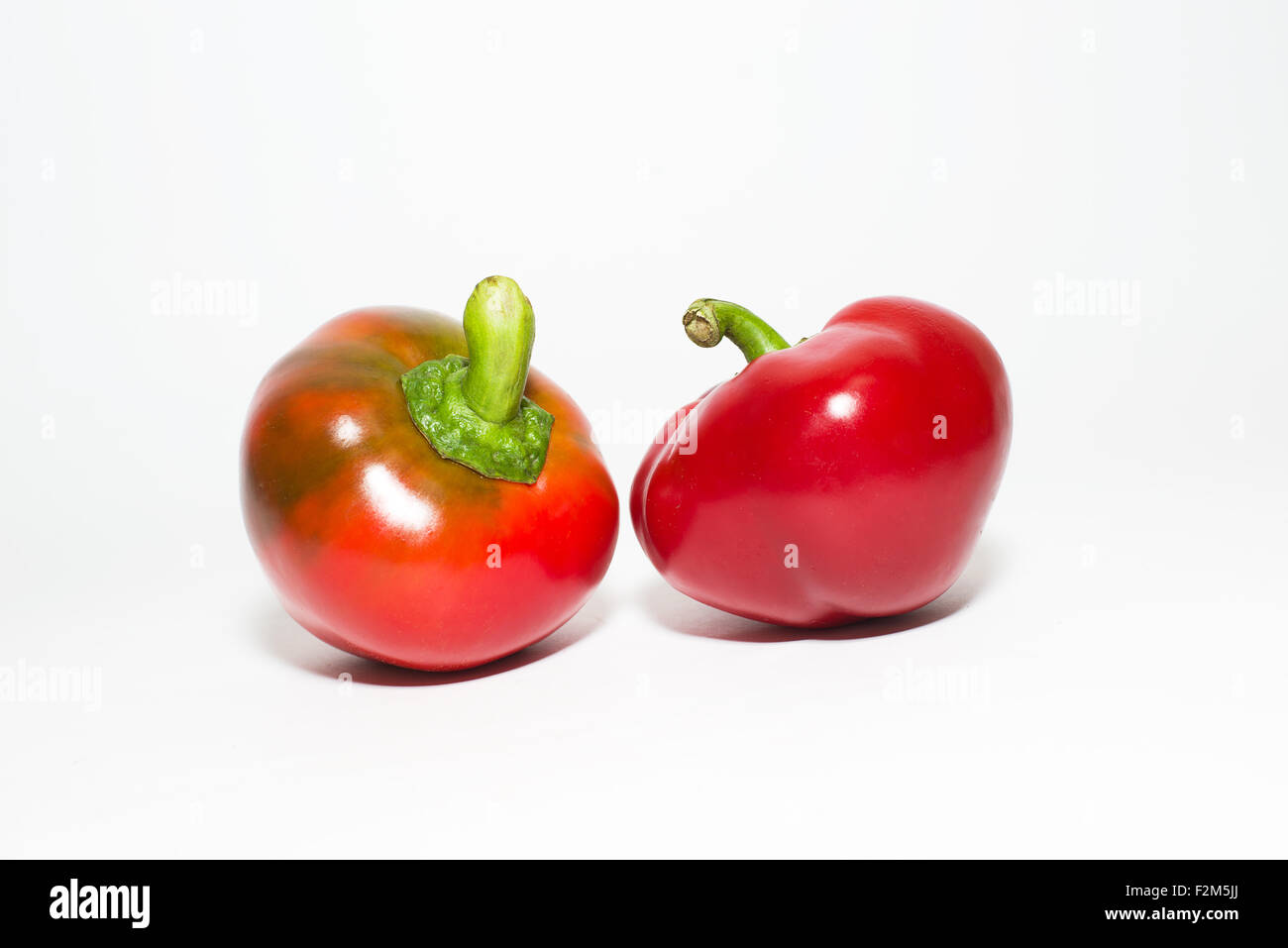 Two peppers on a white background Stock Photo - Alamy