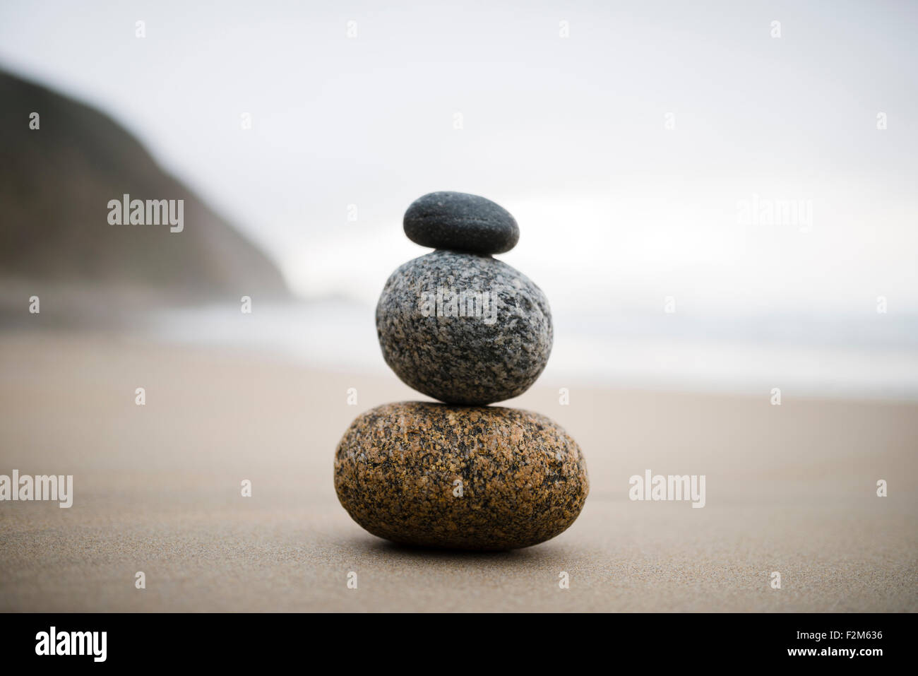 Spain, three rocks balanced on the beach Stock Photo - Alamy
