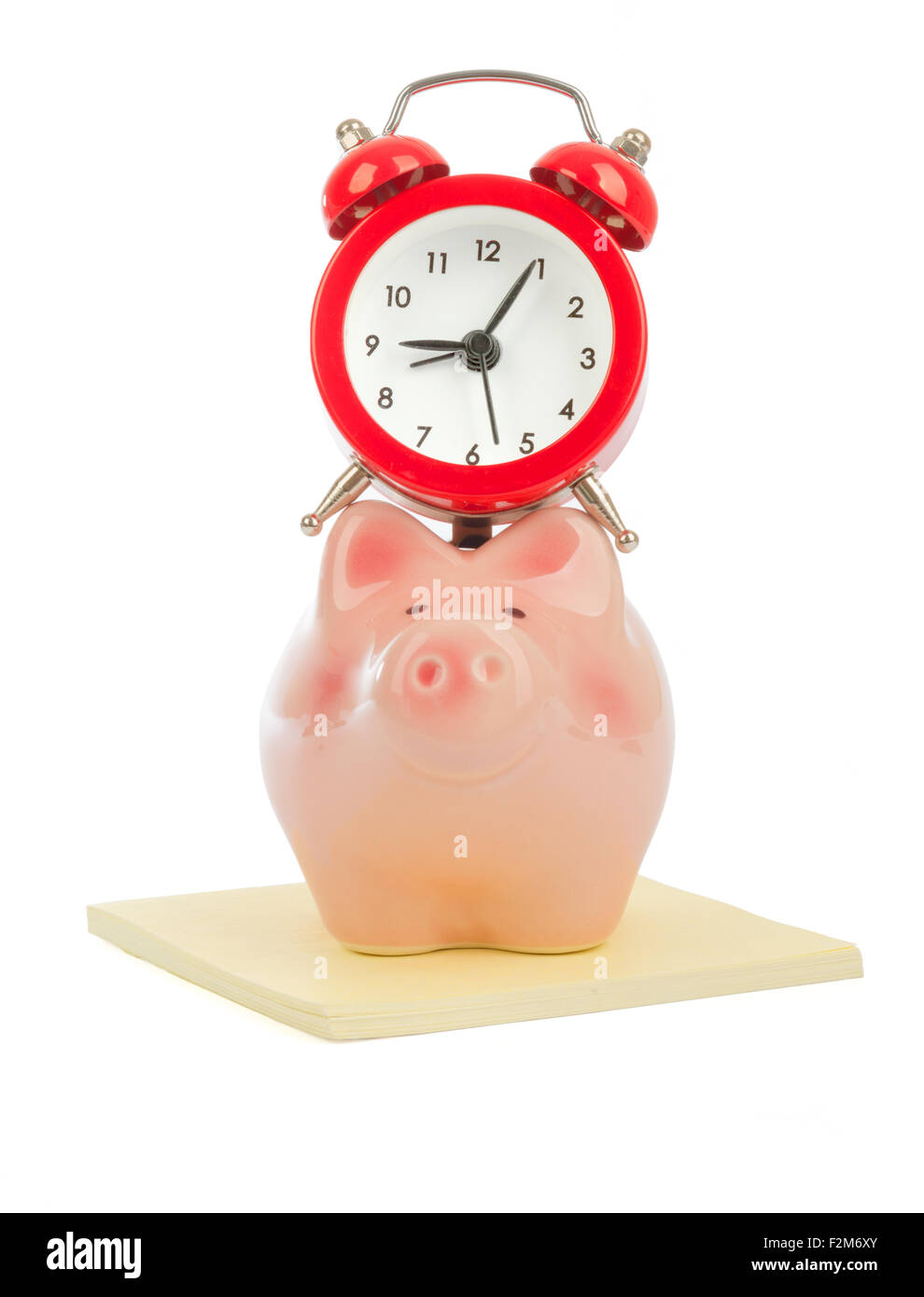 Alarm clock on piggy bank Stock Photo - Alamy