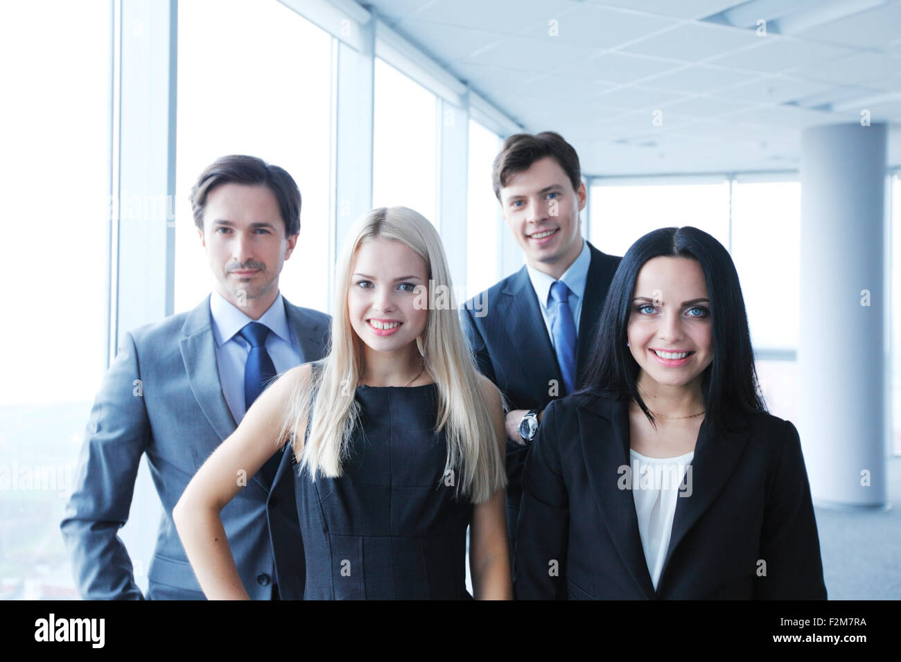 Happy business team of coworkers in office Stock Photo - Alamy