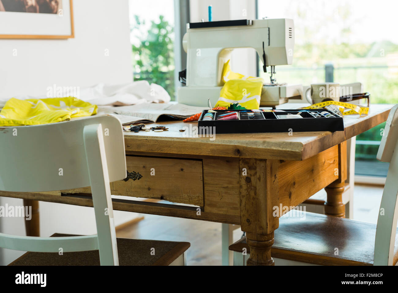 Sewing machine on wooden table Stock Photo - Alamy
