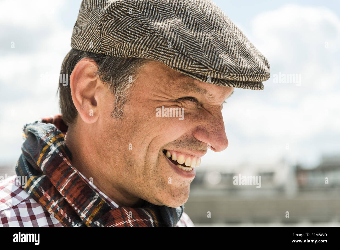 Mature man smiling wearing cap, portrait Stock Photo - Alamy