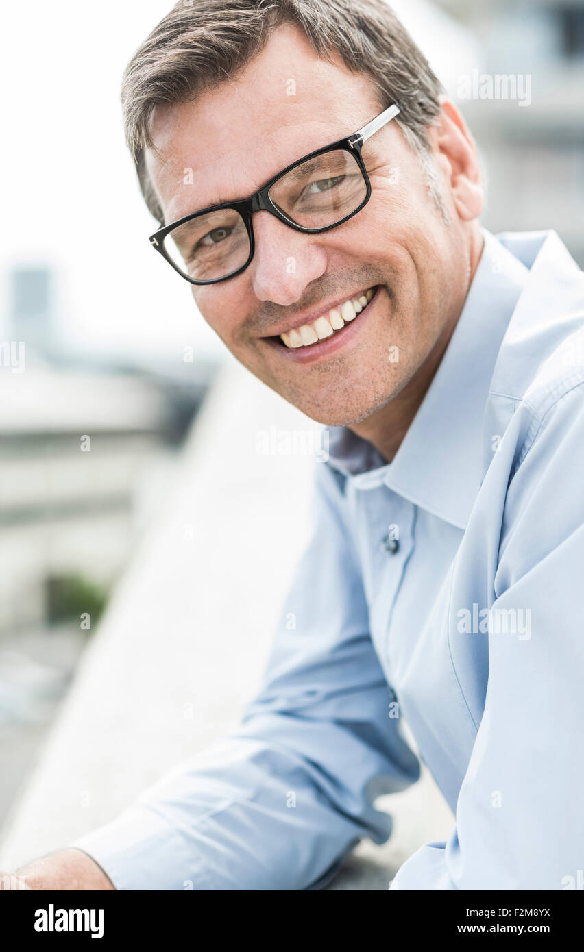 Happy businessman wearing glasses, portrait Stock Photo - Alamy