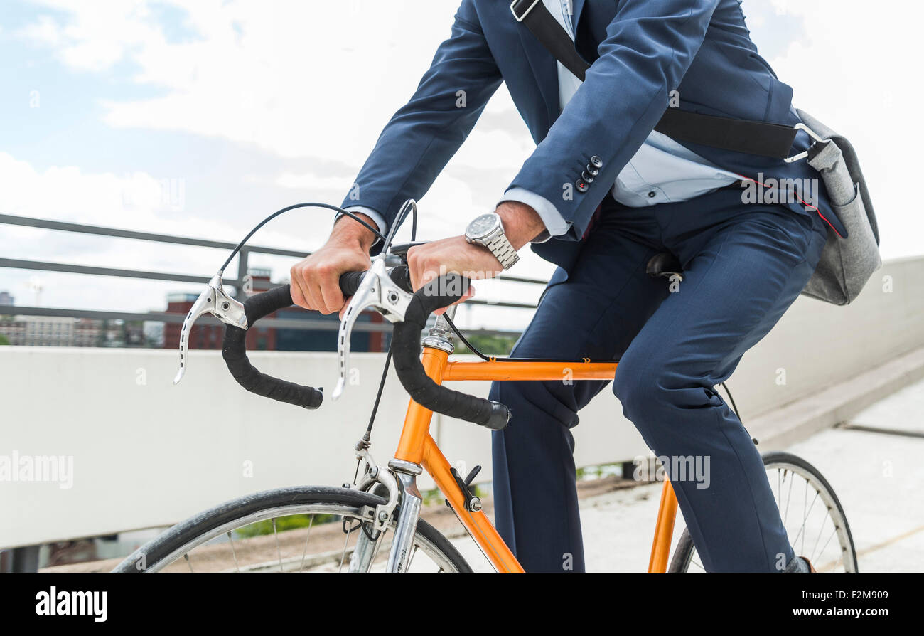 Businessman riding bicycle Stock Photo - Alamy