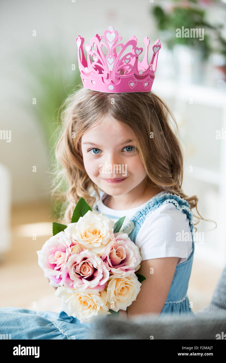 Girl wearing pink crown holding bunch of flowers Stock Photo - Alamy