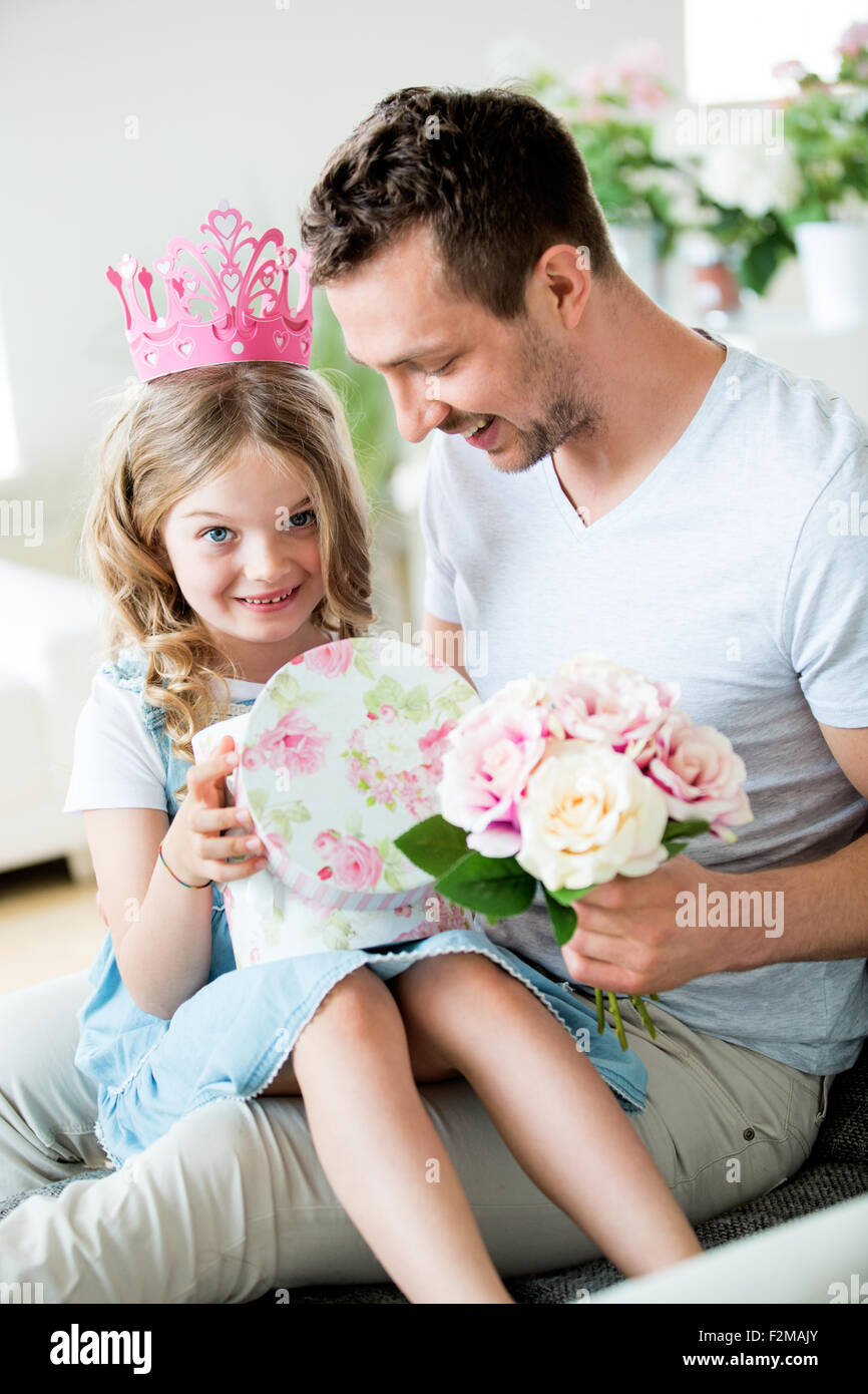 Daughter sitting on fathers lap hi-res stock photography and images - Alamy