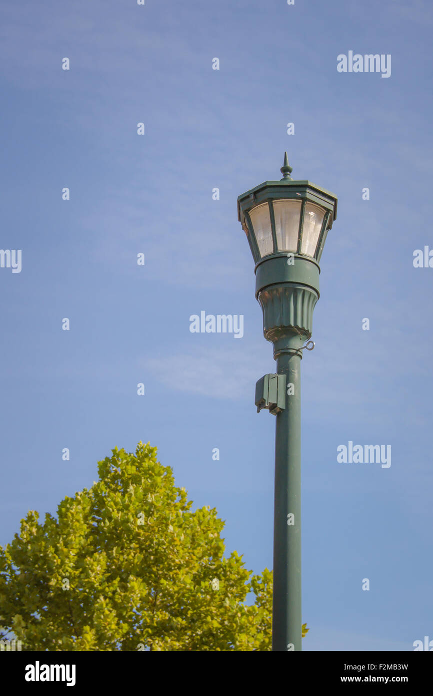 Green street lamp against a blue sky Stock Photo - Alamy