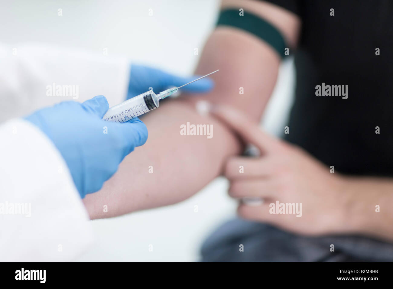 Doctor taking blood sample Stock Photo - Alamy