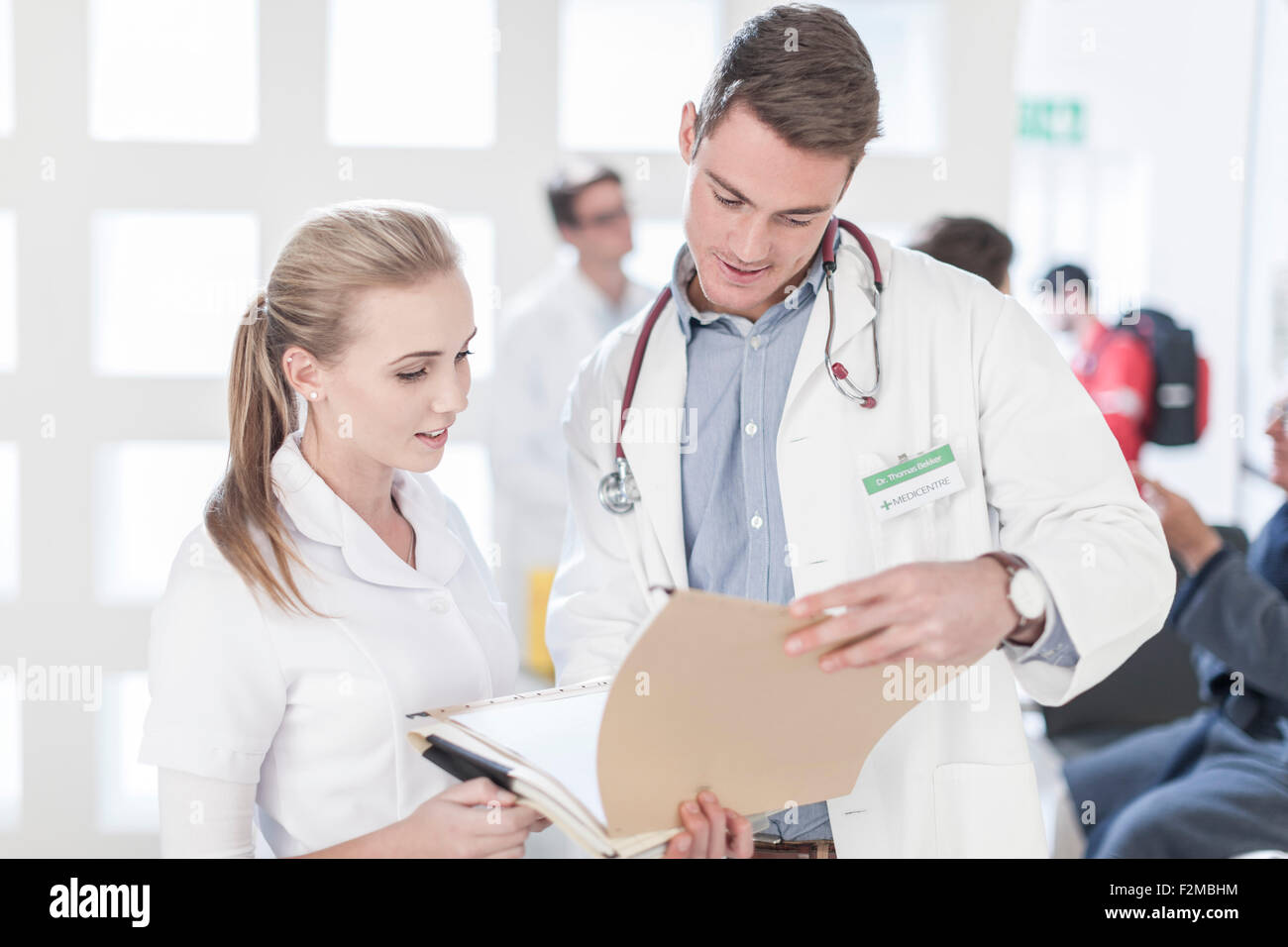 Nurse and doctor looking at patient file Stock Photo - Alamy