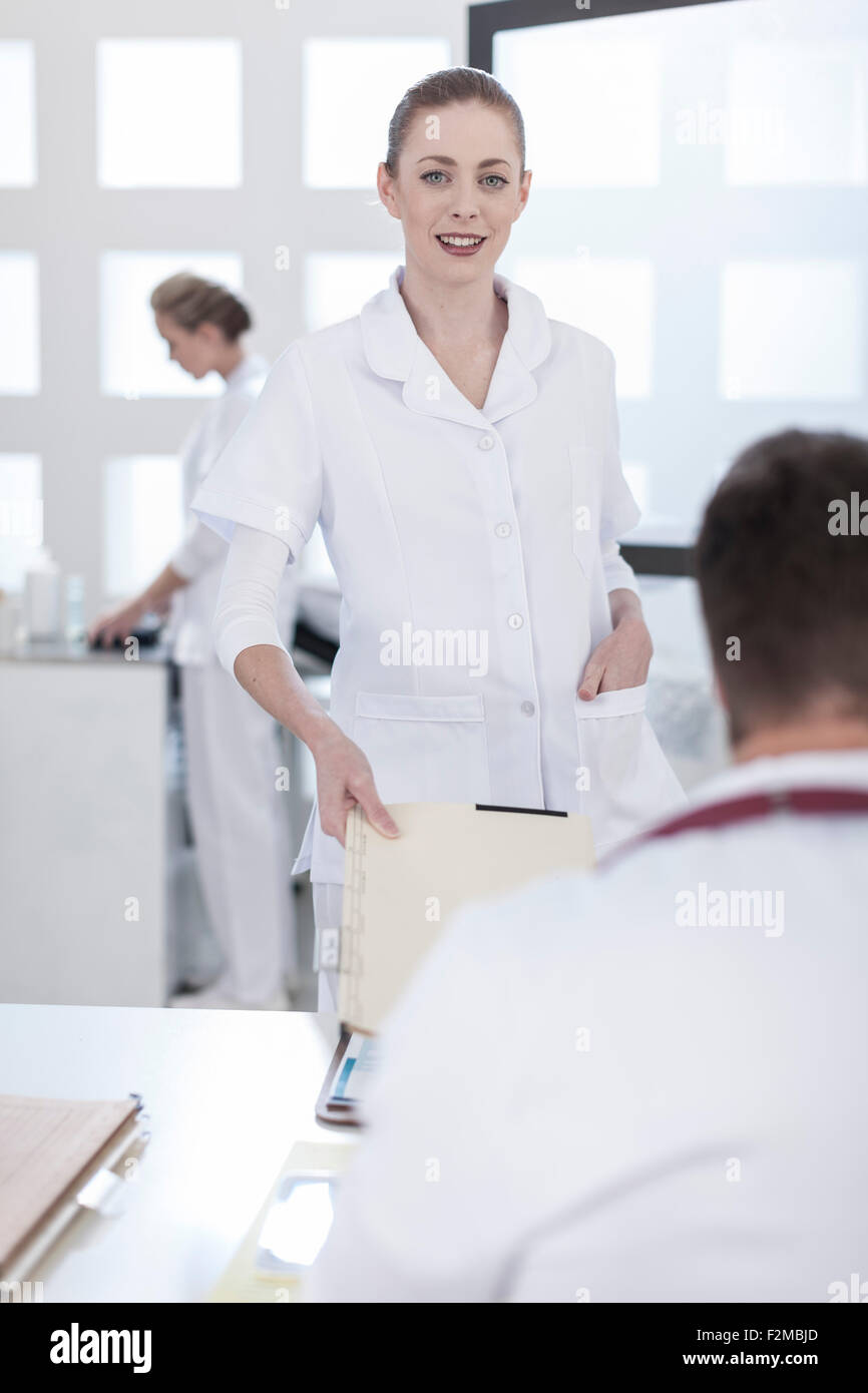 Doctor giving patient documents hi-res stock photography and images - Alamy