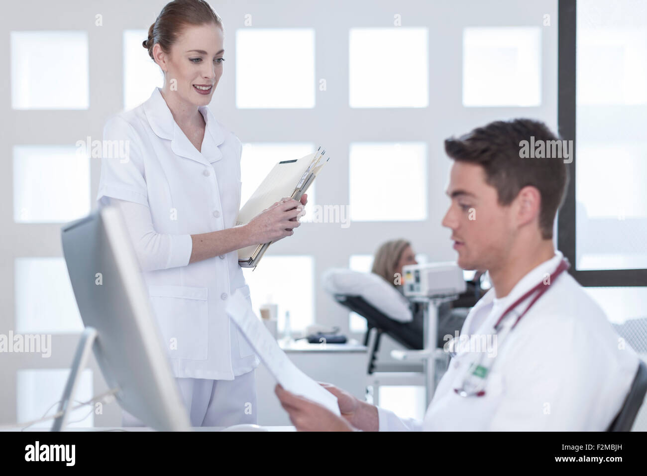 Doctor giving patient documents hi-res stock photography and images - Alamy