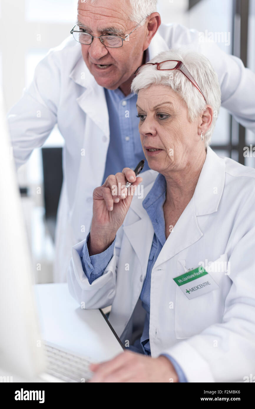 Two doctors talking at desk Stock Photo - Alamy