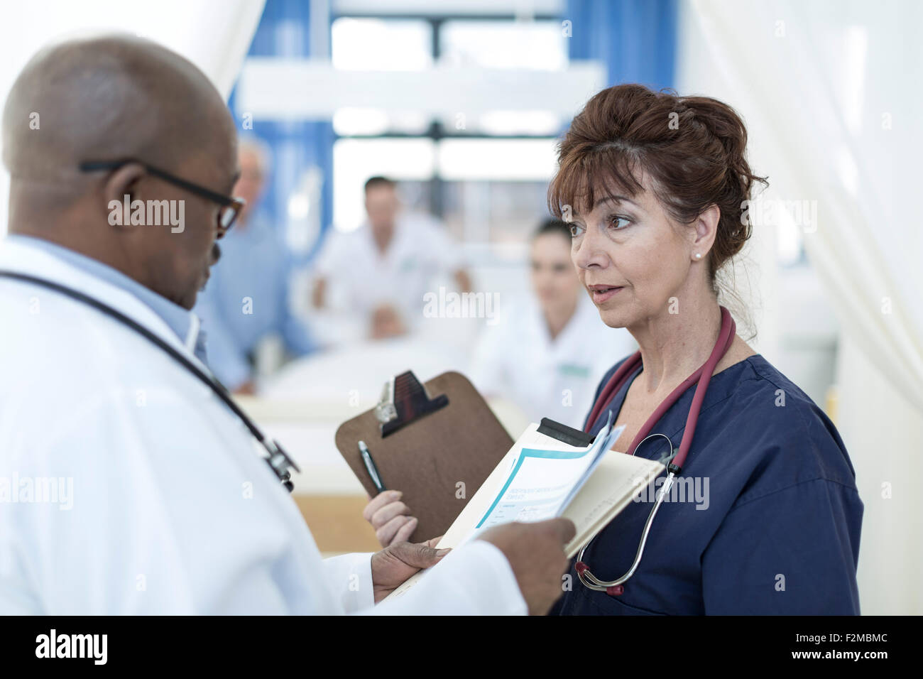 Two doctors in hospital talking Stock Photo - Alamy