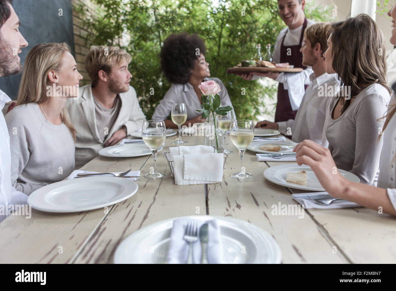 Friends having lunch together at restaurant, sitting outside Stock ...