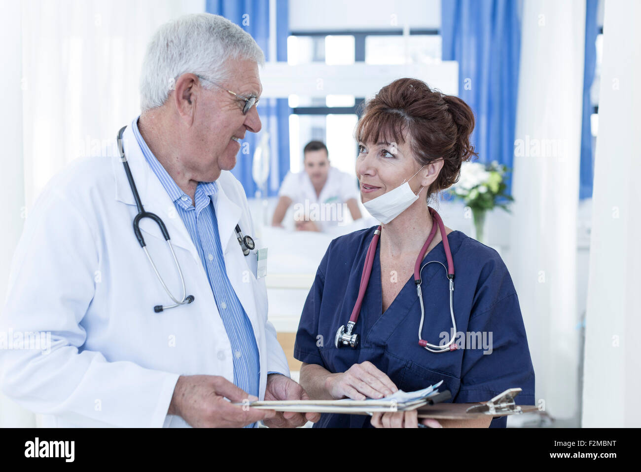 Two doctors in hospital talking Stock Photo - Alamy