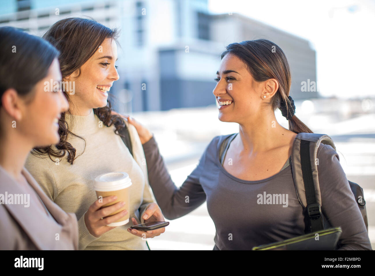 Colleagues having a coffee in the city Stock Photo - Alamy