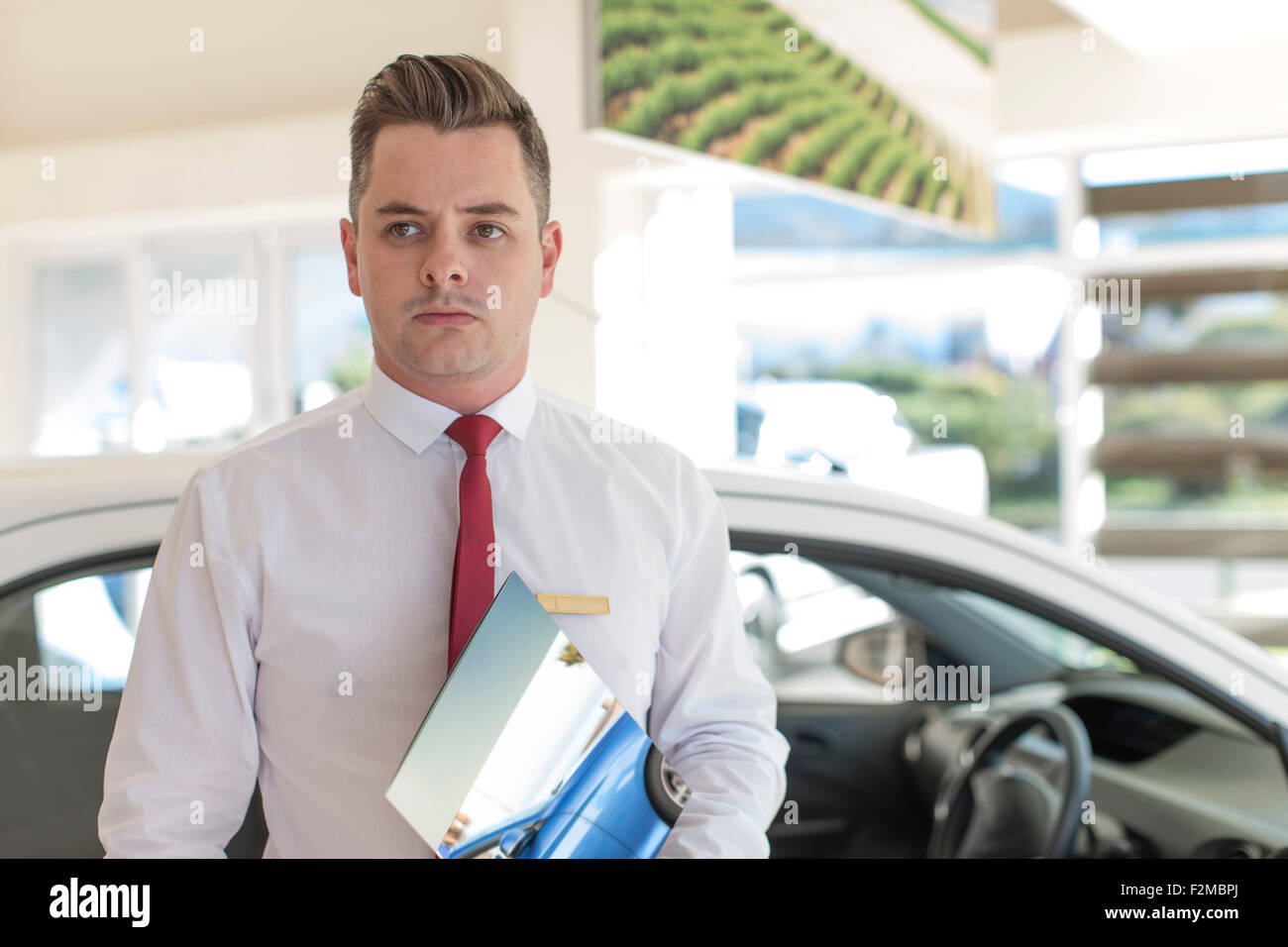 Car dealer in showroom Stock Photo - Alamy