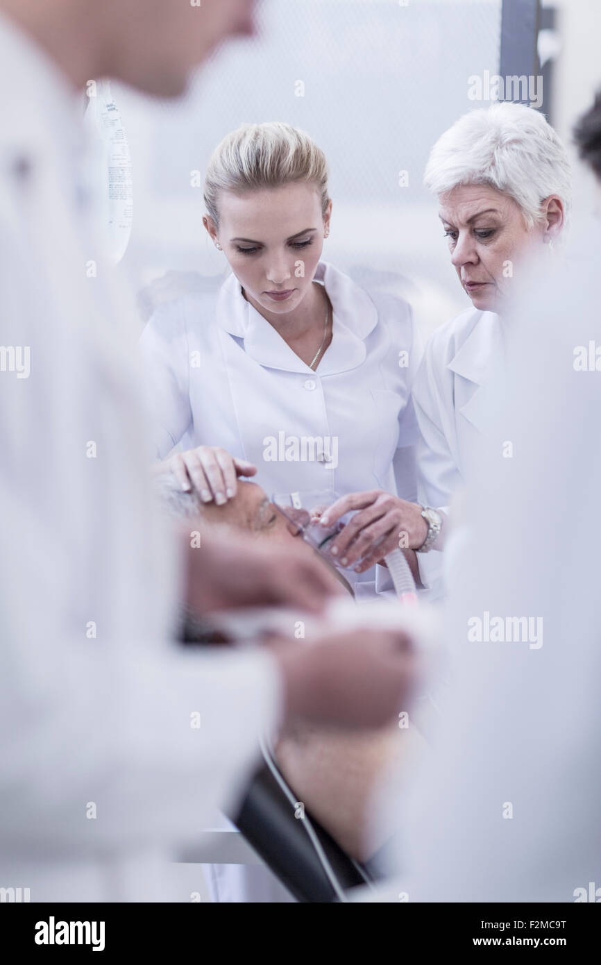 Hospital staff helping patient in emergency Stock Photo - Alamy