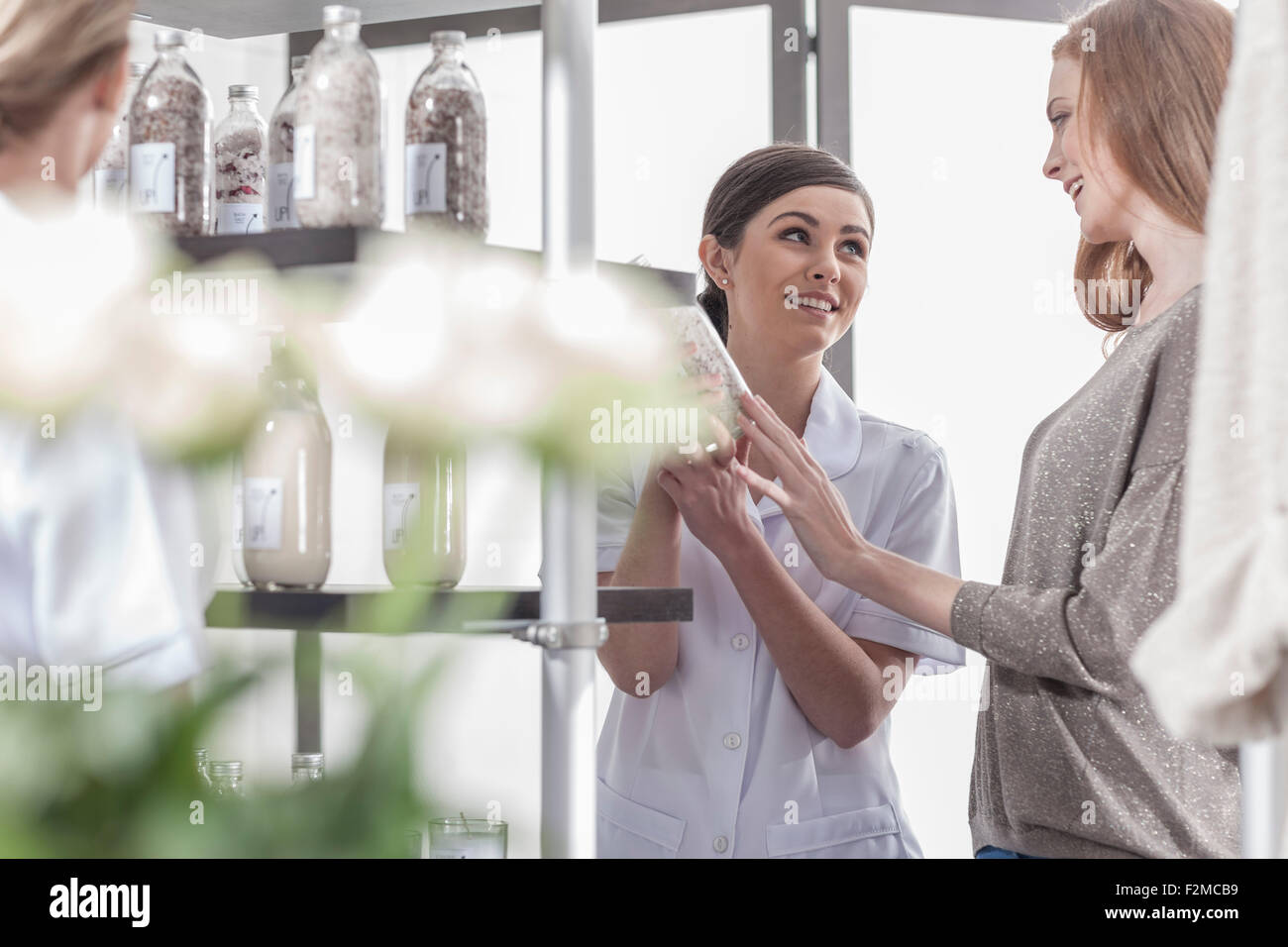 Client and shop assistant talking in wellness shop Stock Photo - Alamy