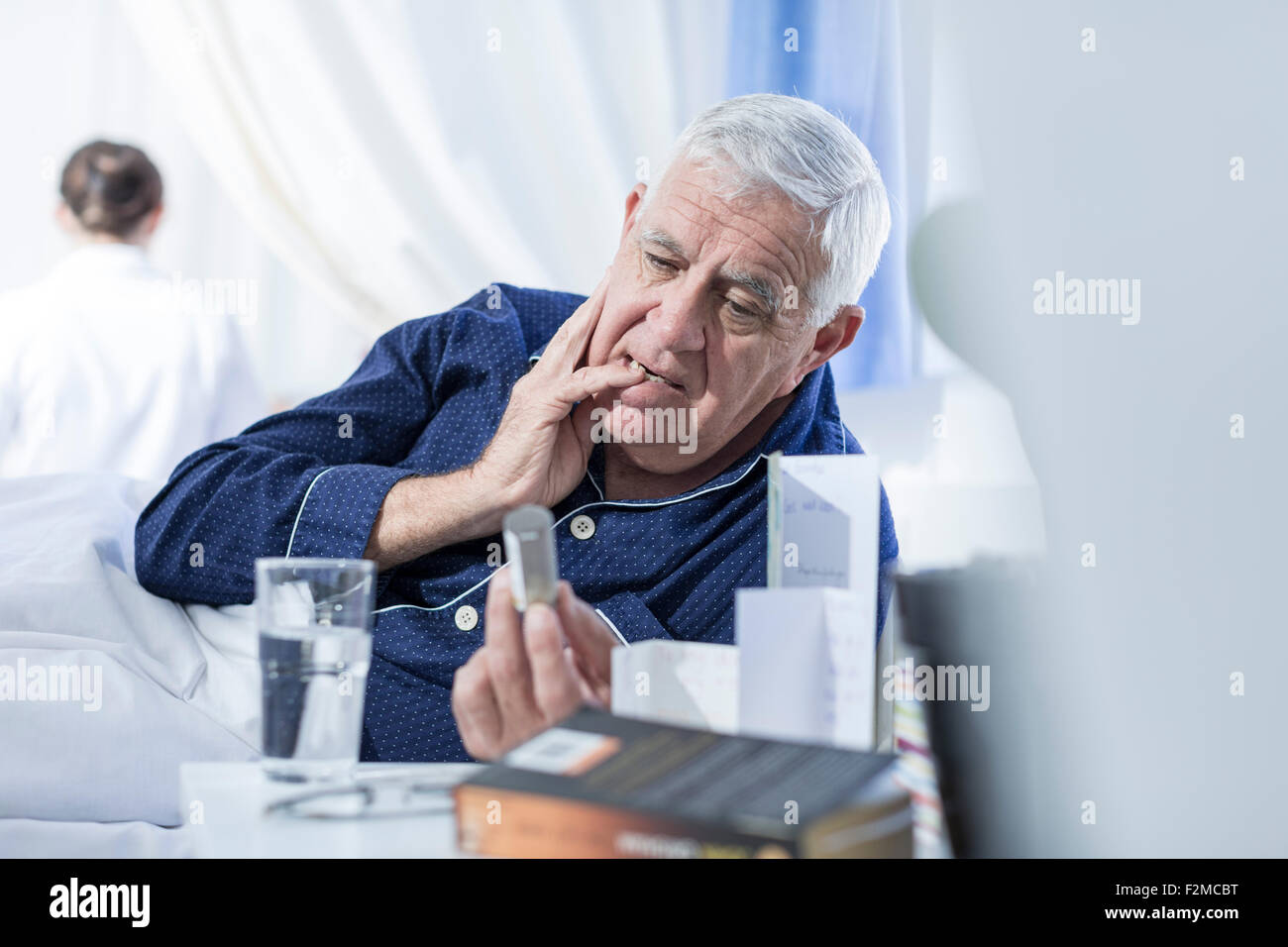 Patient in hospital taking medication Stock Photo - Alamy