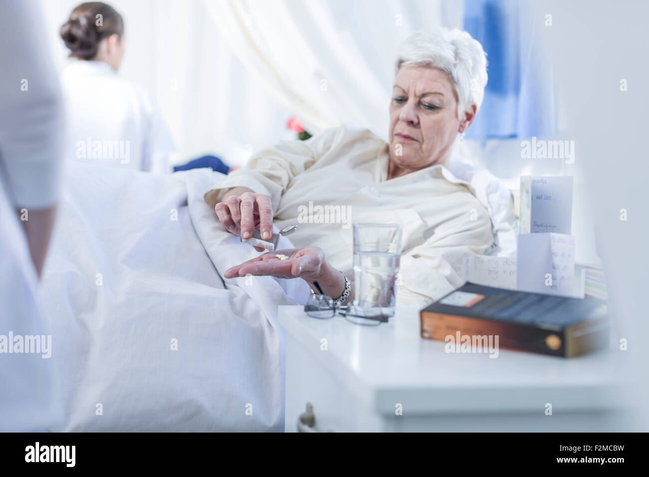 Hospital patient taking medication Stock Photo - Alamy