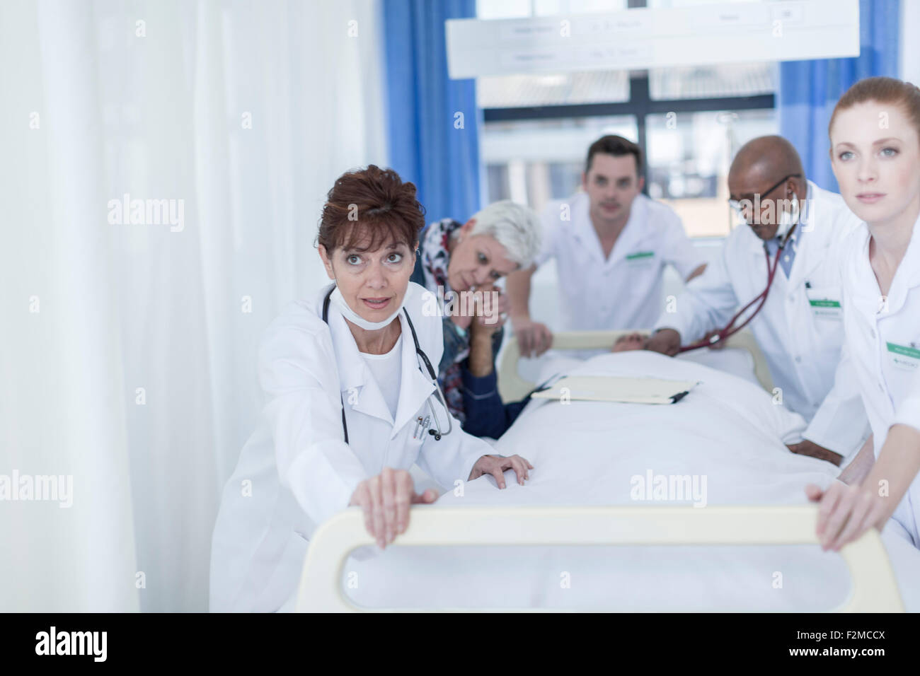 Doctor's moving patient with bed in emergency Stock Photo - Alamy