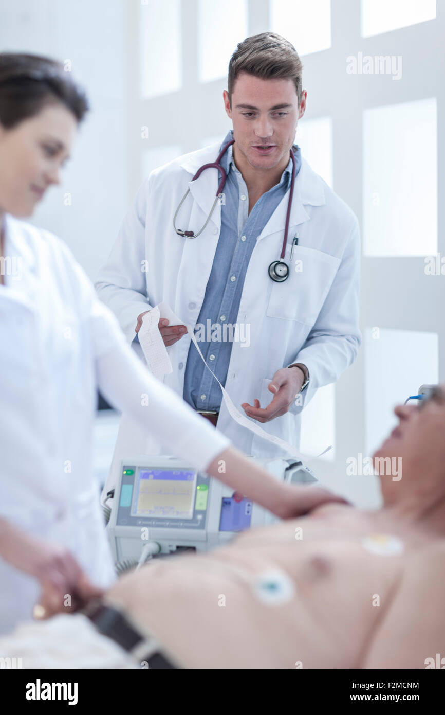 Senior man doing check up in hospital, nurse calming him Stock Photo ...
