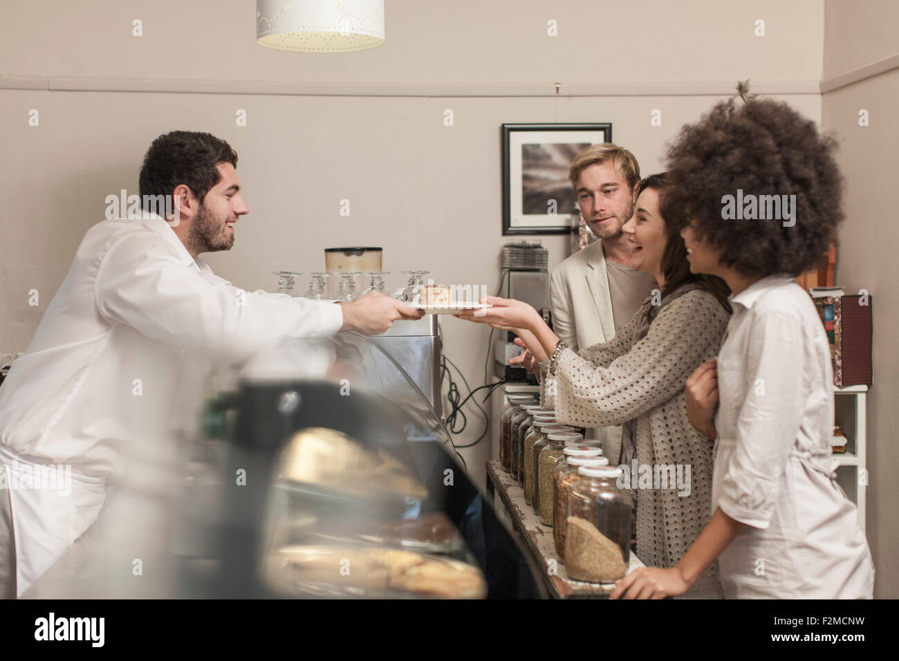 Customers queuing at cake counter in coffee shop Stock Photo - Alamy