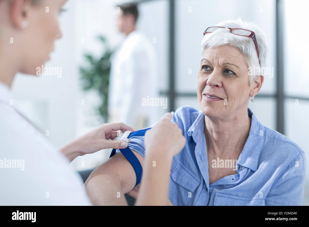 Senior woman doing check up at the doctor's Stock Photo - Alamy