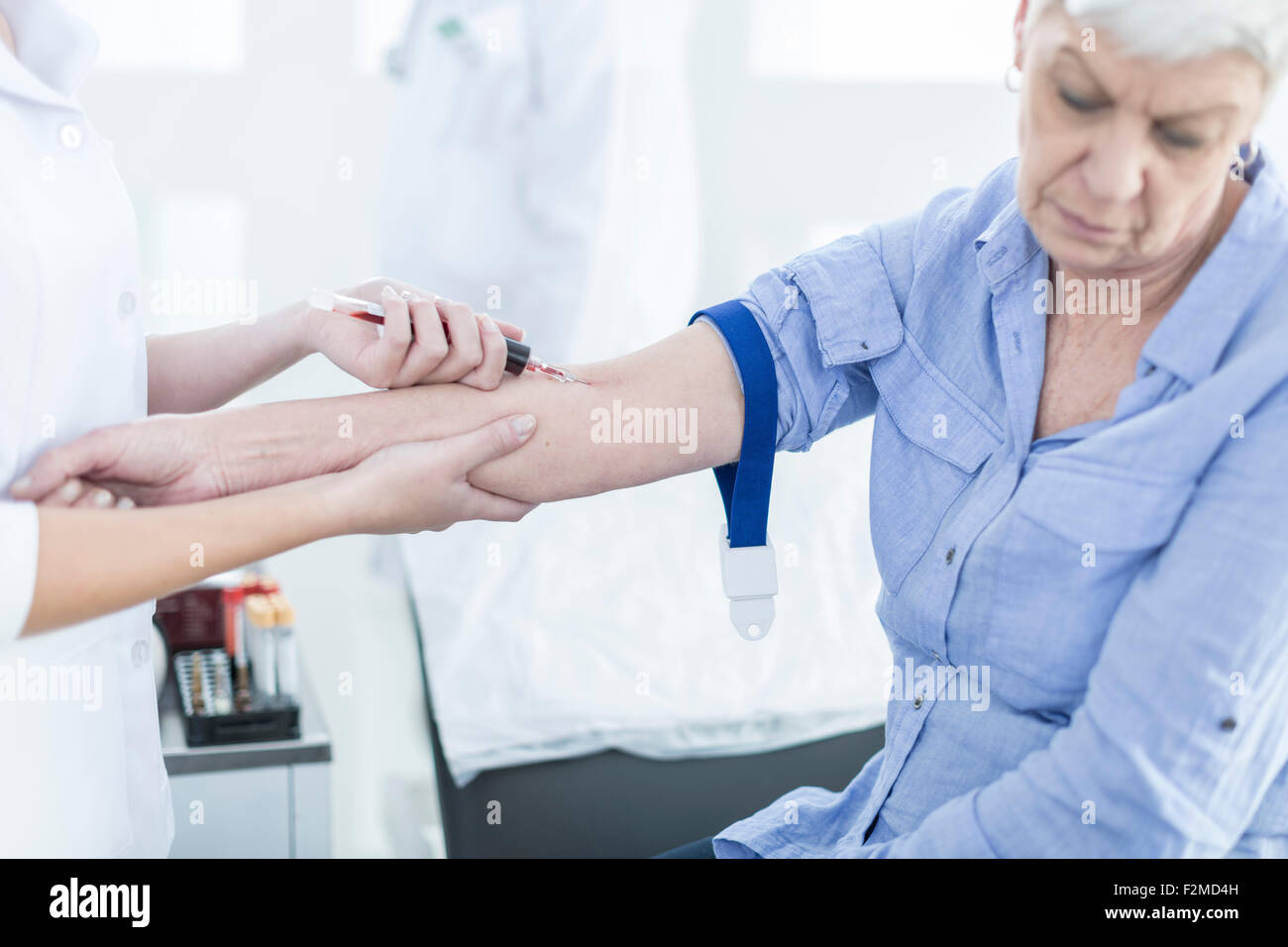 Nurse taking blood from patient, close up Stock Photo - Alamy