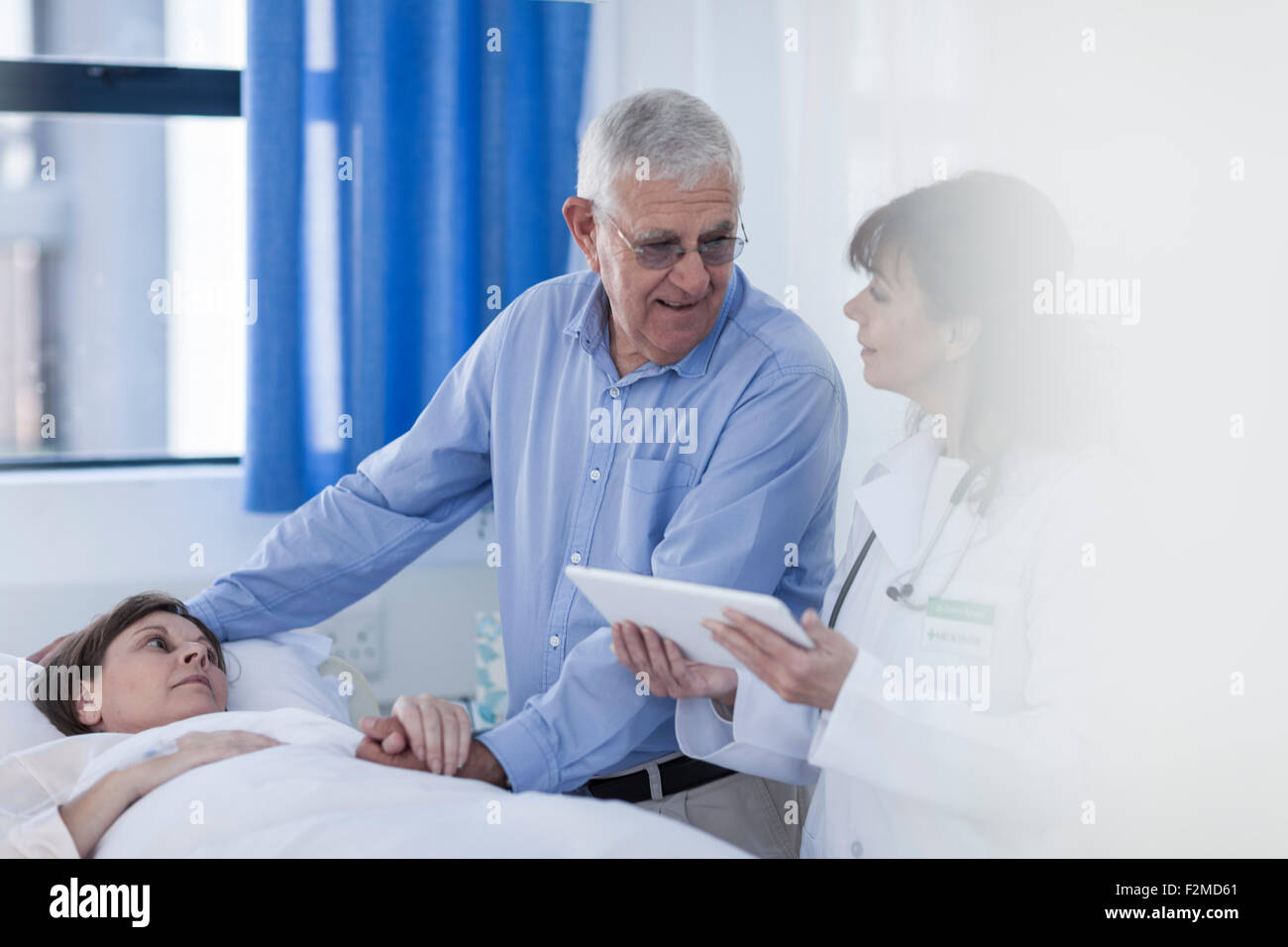 Senior man and doctor visiting patient in hospital Stock Photo - Alamy