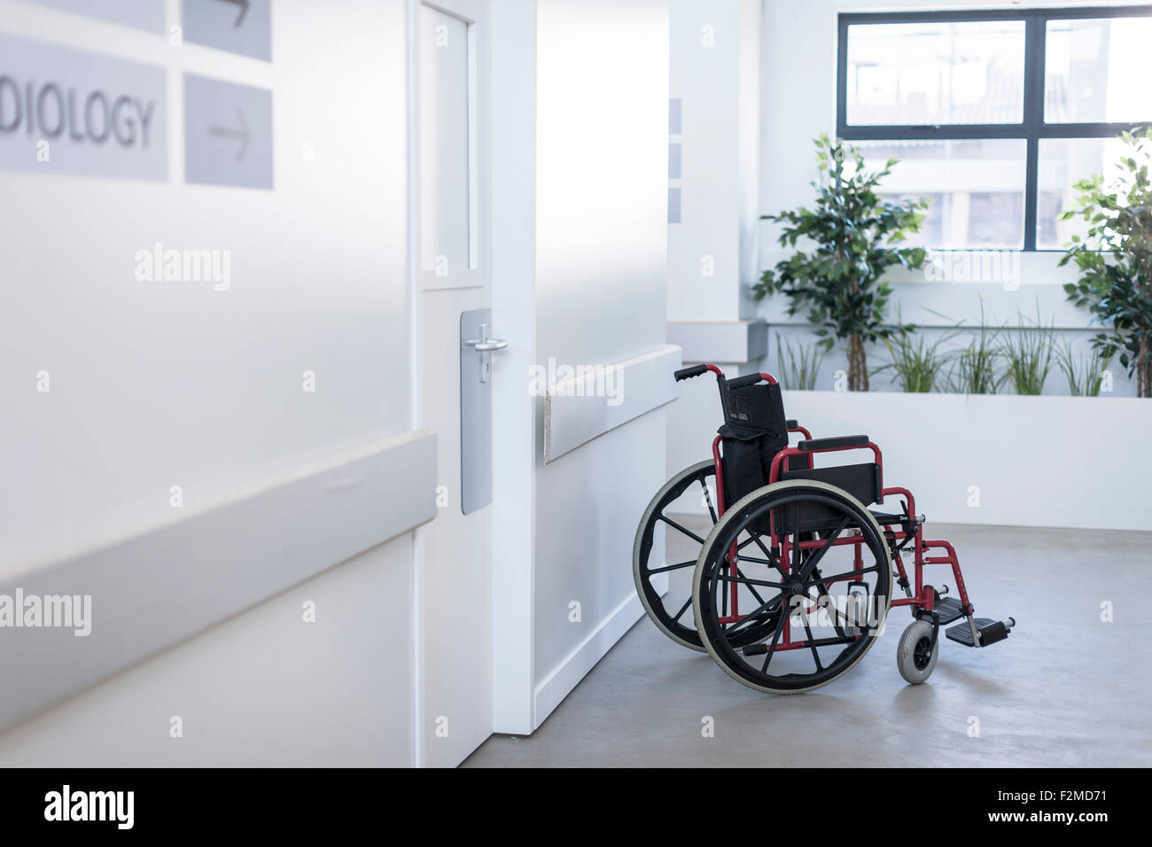 Wheelchair in hospital corridor Stock Photo - Alamy