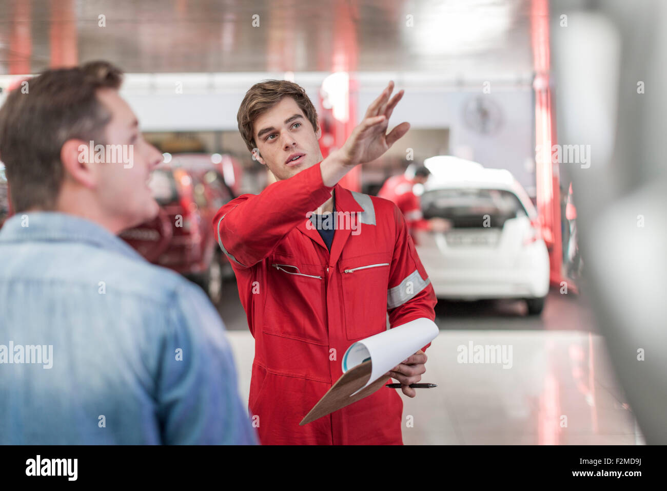 Car mechanic and customer in repair garage Stock Photo - Alamy