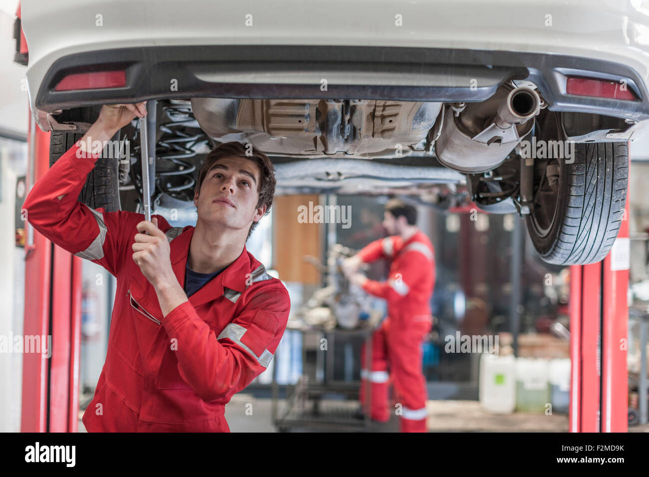 Car mechanic at work in repair garage Stock Photo - Alamy