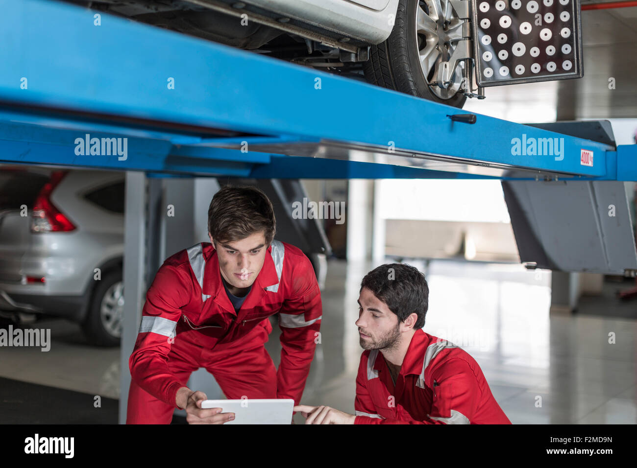Car mechanic at work in repair garage Stock Photo - Alamy