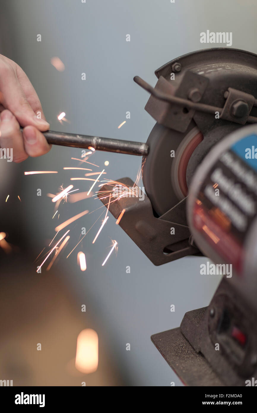 Car mechanic at work in repair garage, grinding machine Stock Photo - Alamy