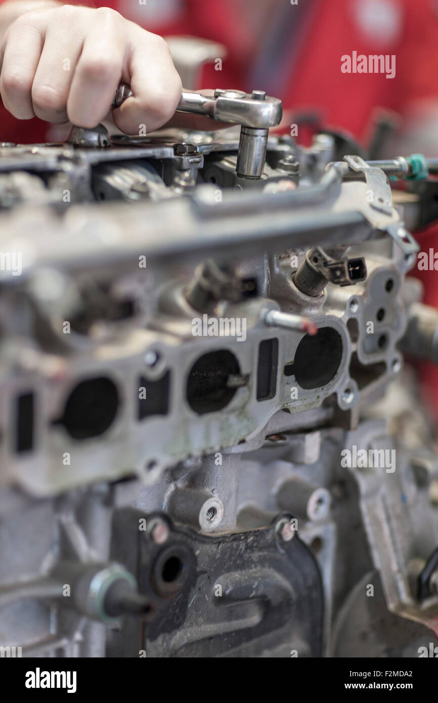Car mechanic at work in repair garage, checking motor Stock Photo - Alamy