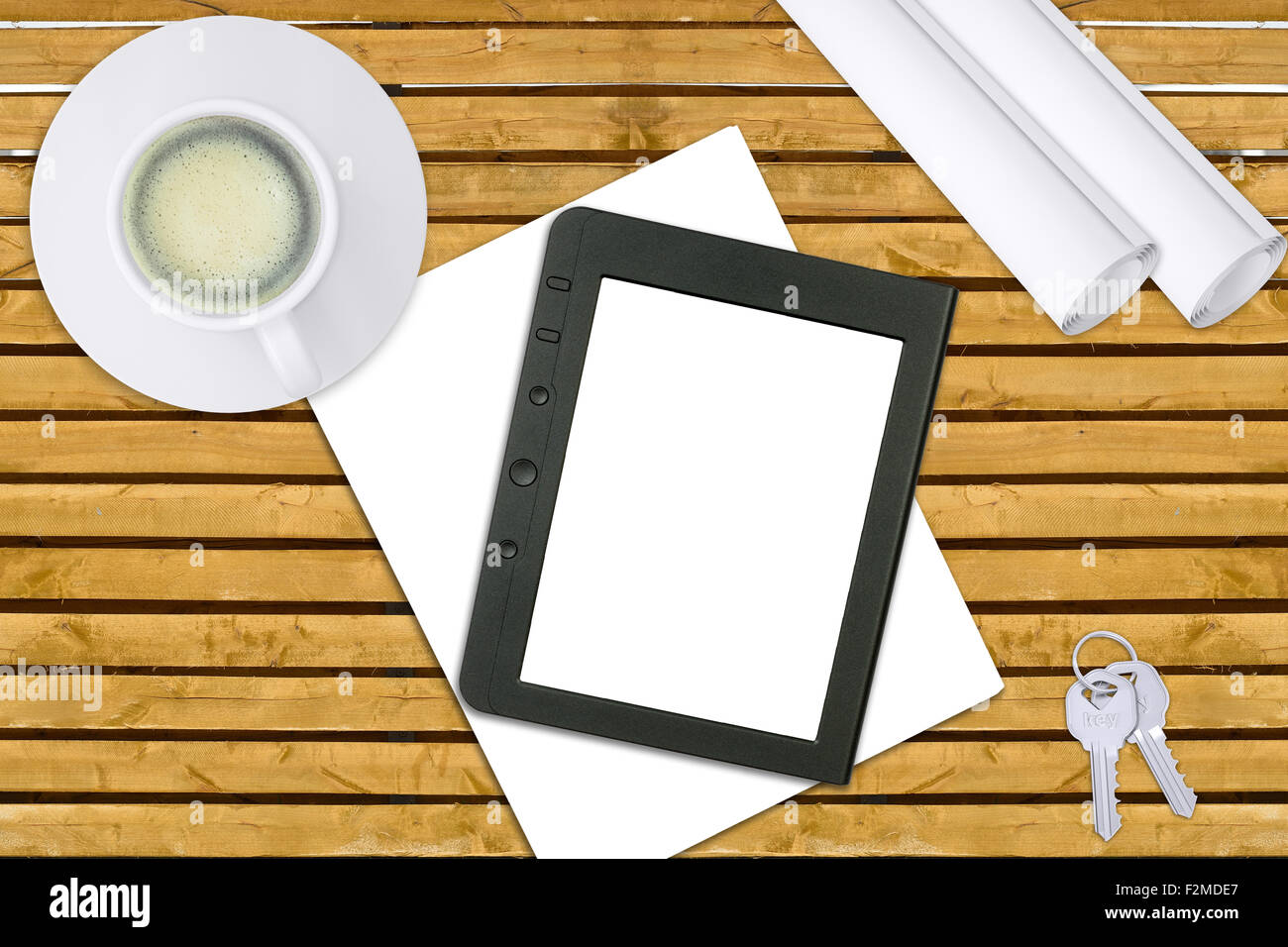 Tablet with keys on table Stock Photo - Alamy