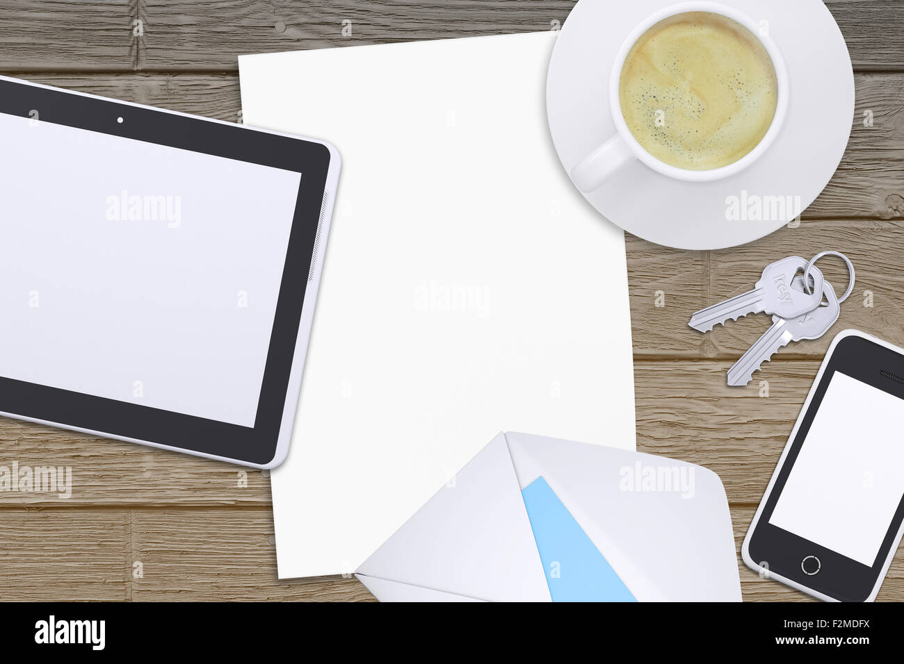 Tablet with smartphone and keys on table Stock Photo - Alamy