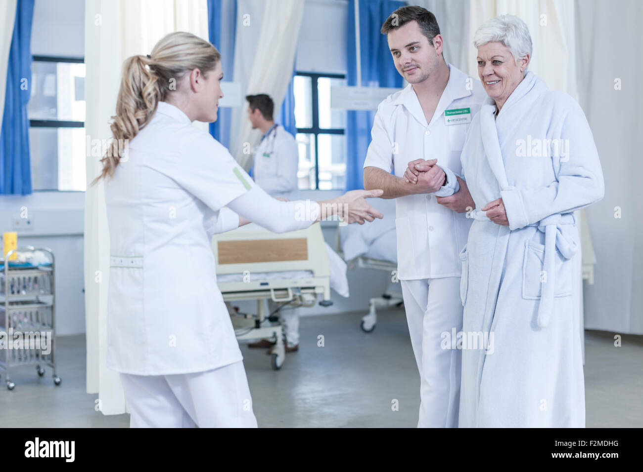 Hospital staff supporting senior patient Stock Photo - Alamy