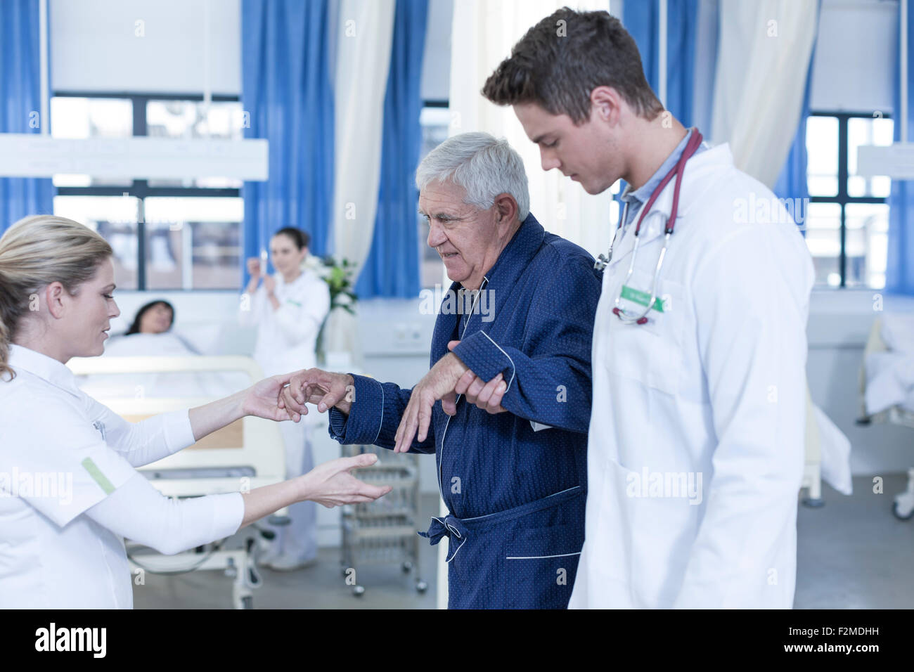 Hospital staff supporting senior patient Stock Photo - Alamy