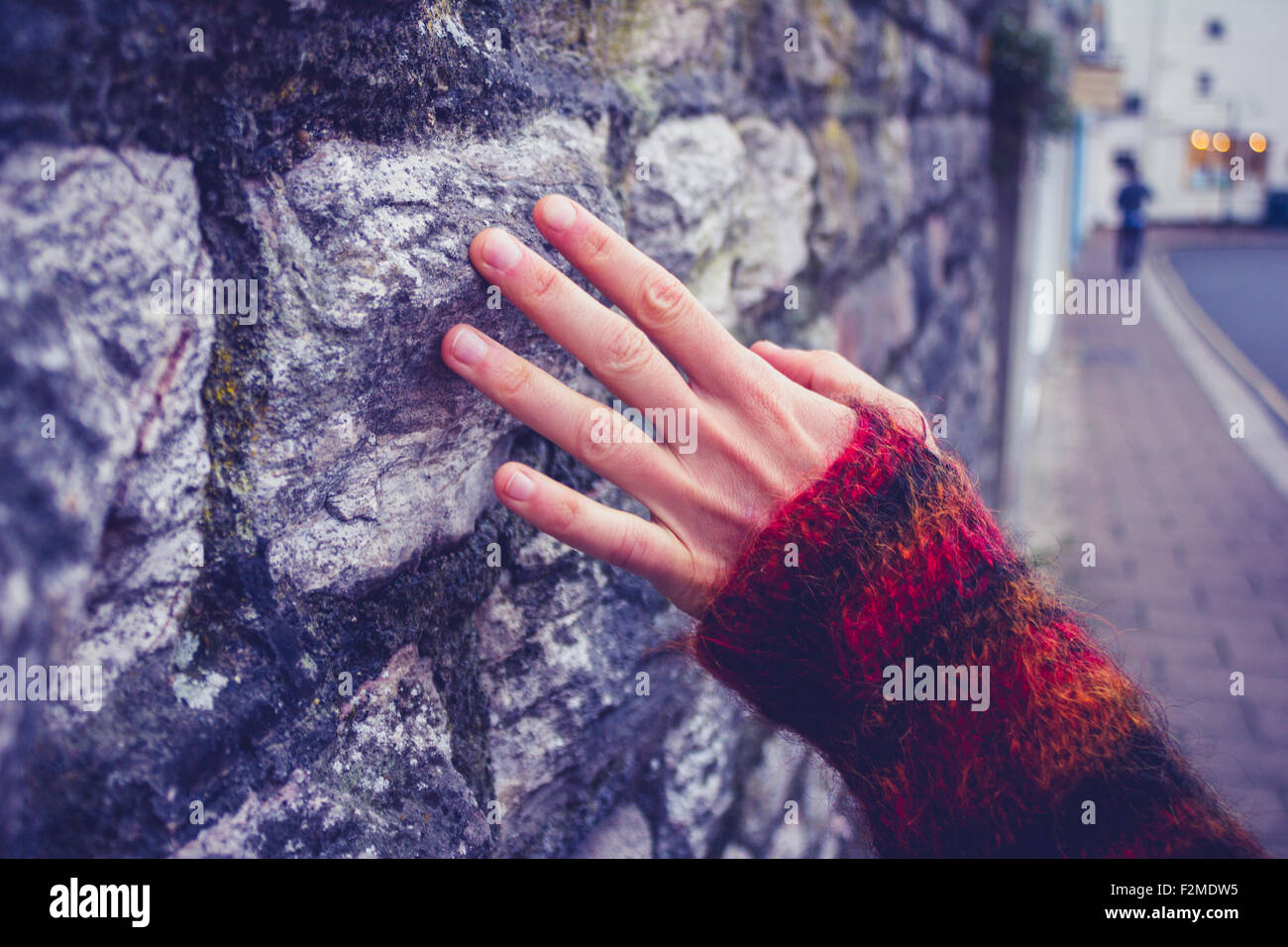 Woman's hand touching wall outside Stock Photo - Alamy