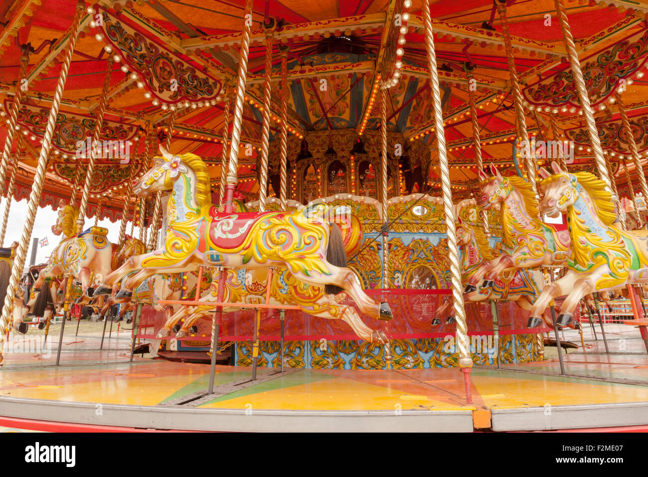 Carousel at a funfair, empty showing the horses Stock Photo - Alamy