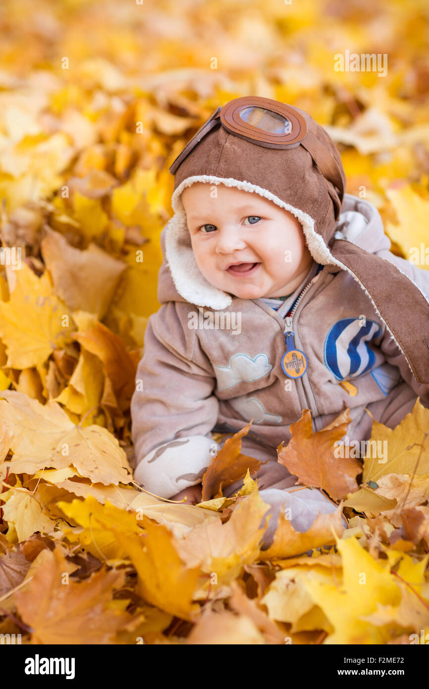 Cute baby in autumn leaves. First autumn Stock Photo - Alamy