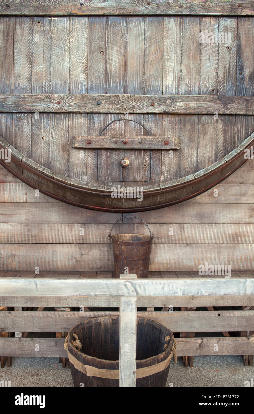 View of big wine barrel and wooden bucket Stock Photo - Alamy
