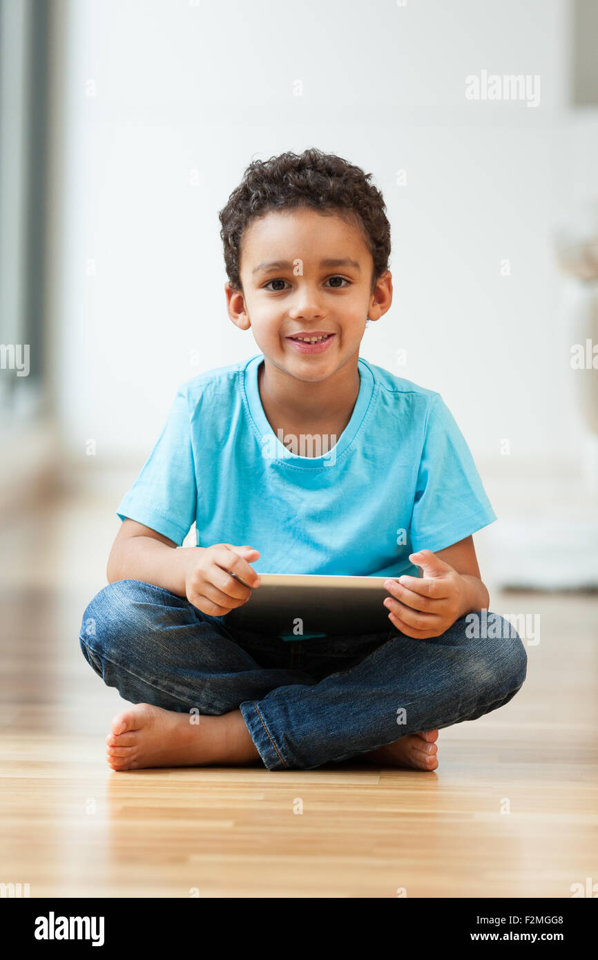 African american little boy using a tactile tablet Stock Photo - Alamy