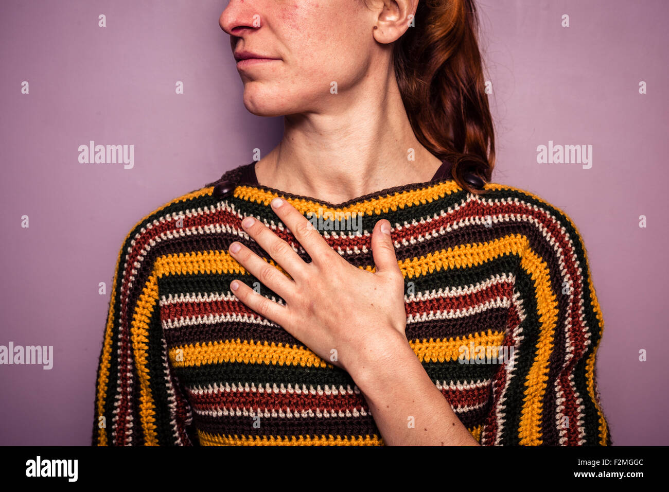Woman touching chest hi-res stock photography and images - Alamy